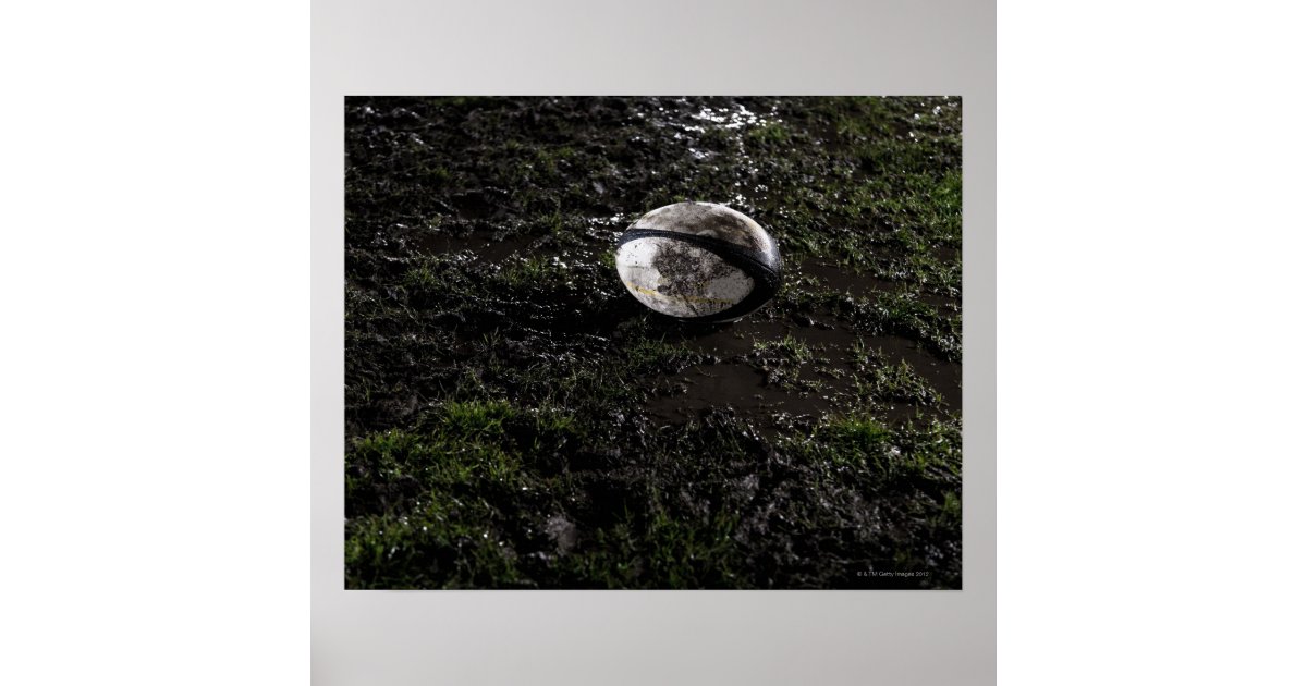Muddy rugby ball sitting on a chewed up grass poster | Zazzle